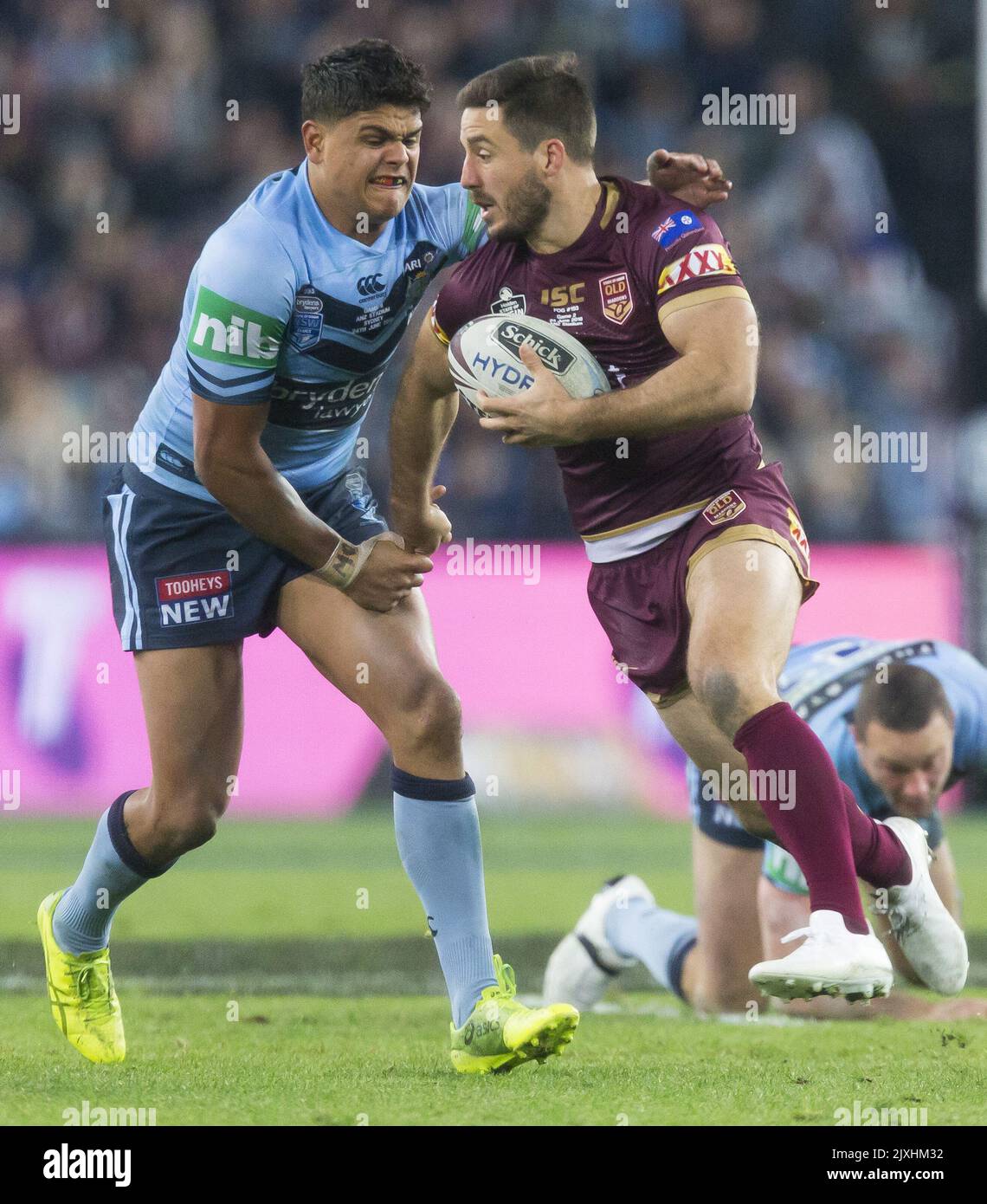 Latrell Mitchell of the Blues tackles Ben Hunt of the Maroons during ...