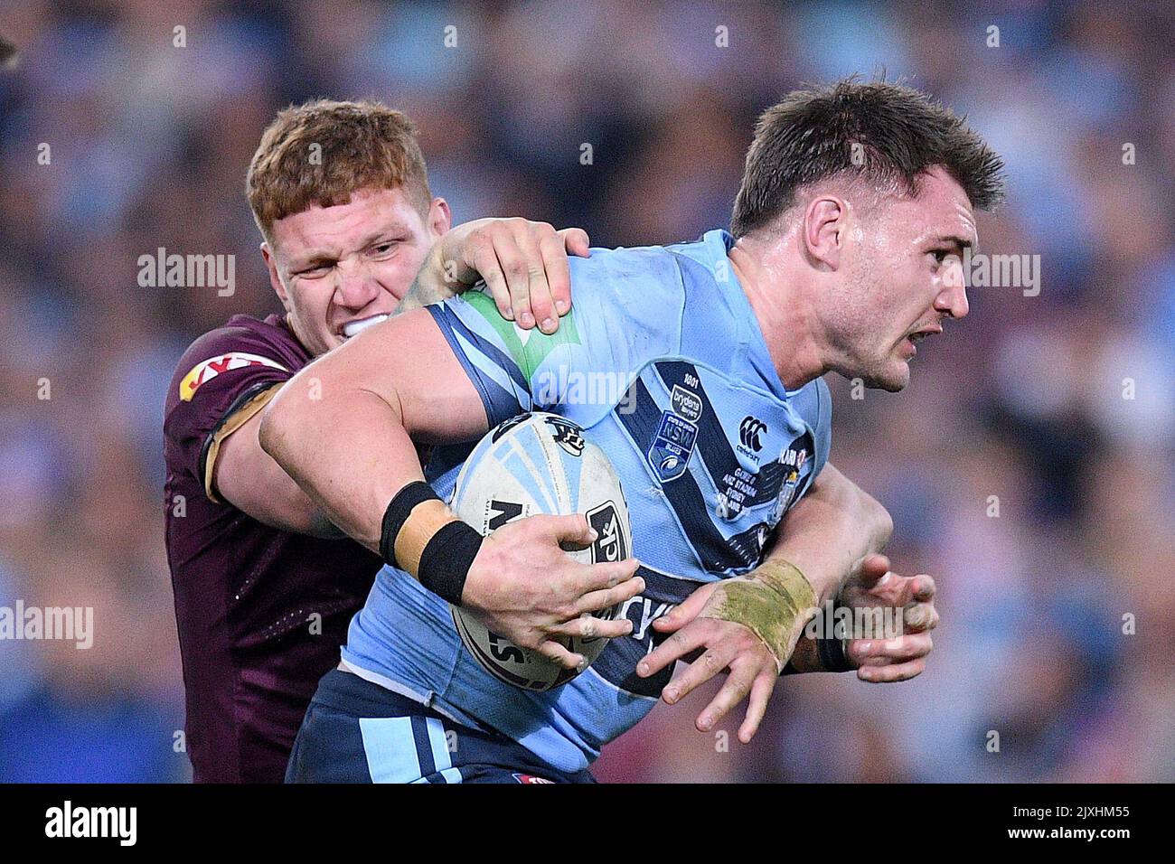 Angus Crichton of the Blues is tackled by Dylan Napa of the Maroons ...