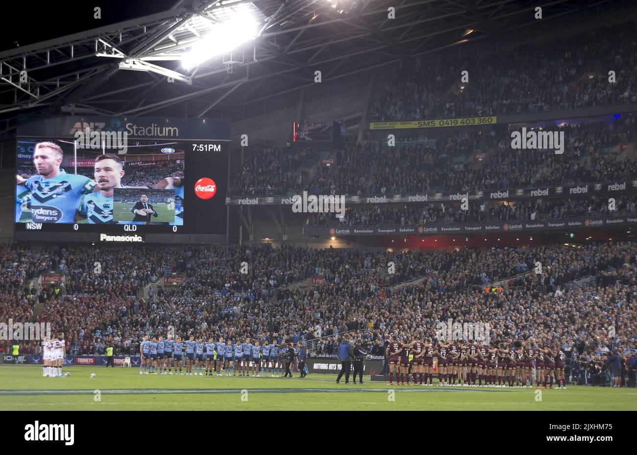 NSW and QUEENSLAND line up for the national anthem before the start of ...