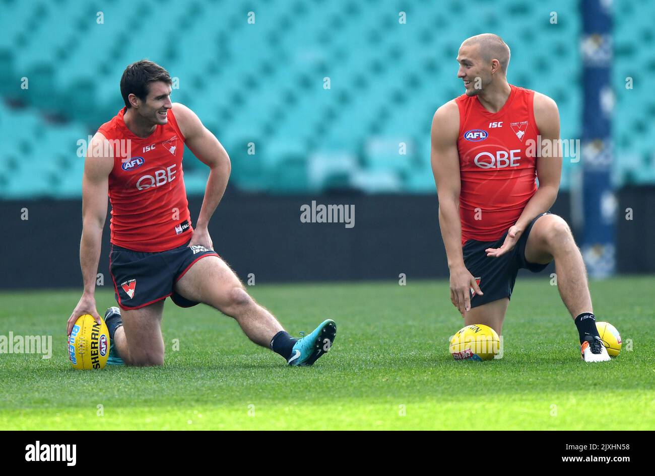Dean Towers and Sam Reid of the Sydney Swans speak to each other during ...