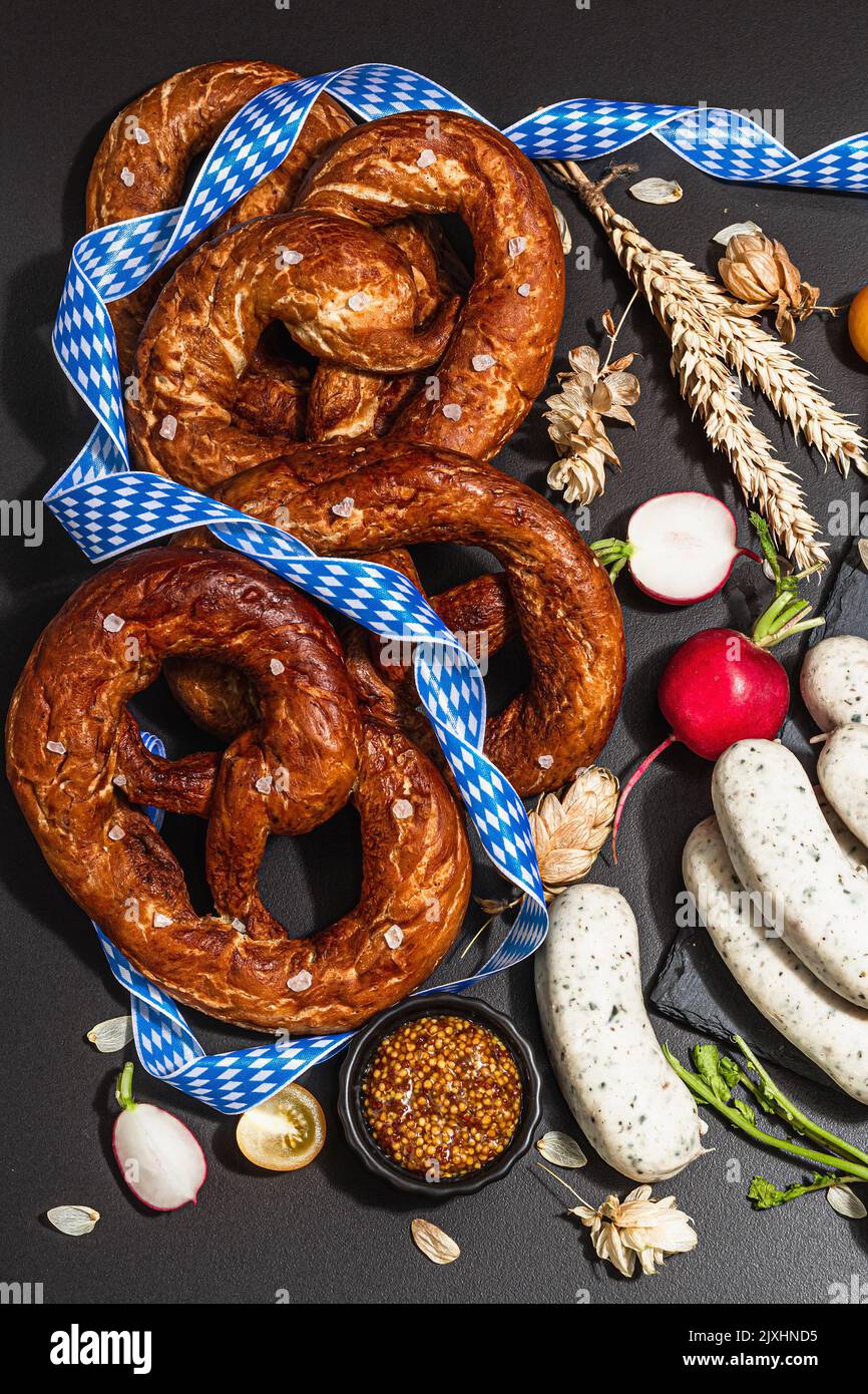 Traditional Oktoberfest set. Pretzels, weisswurst, smoked pork knuckle ...