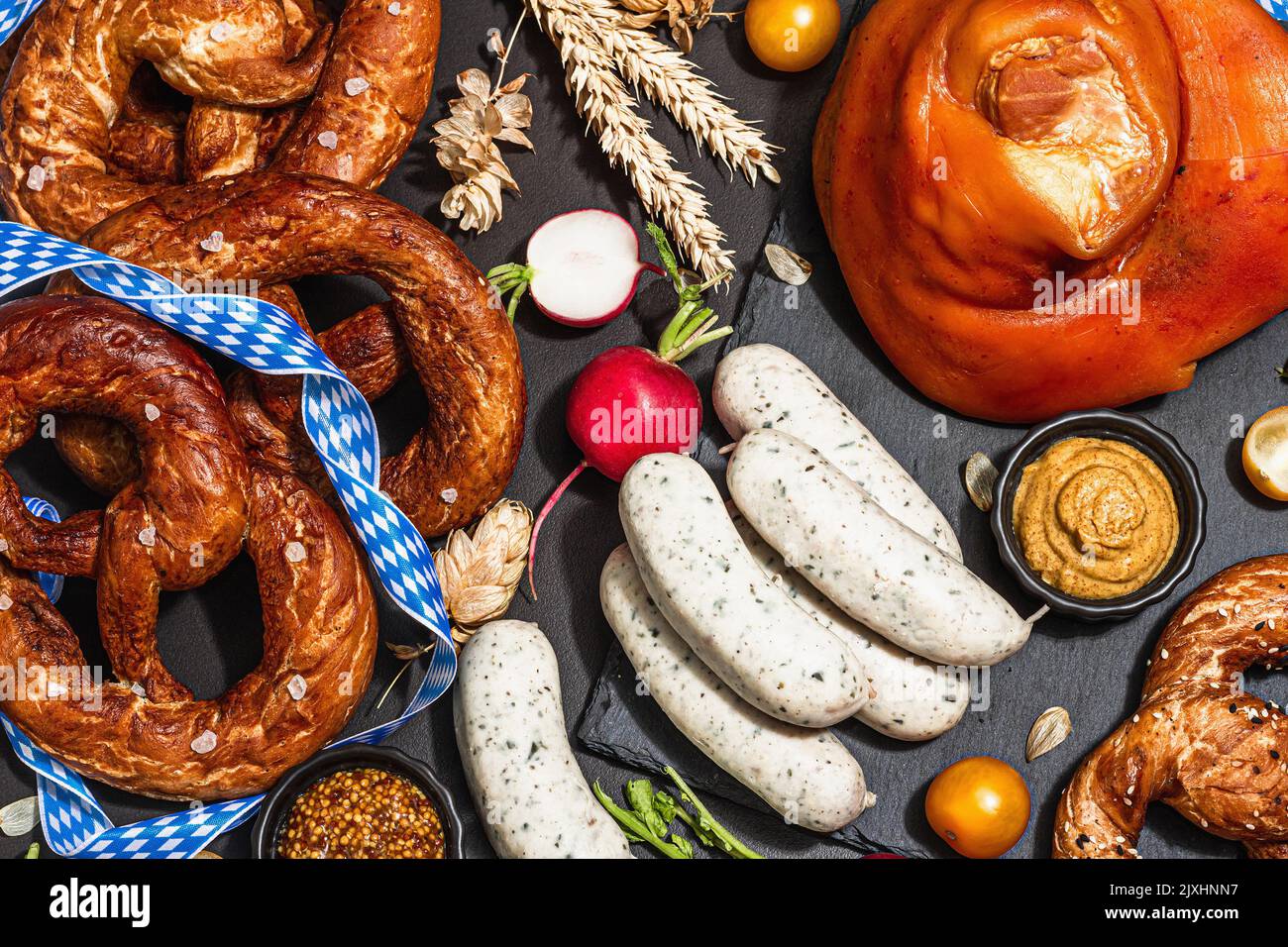 Traditional Oktoberfest set. Pretzels, weisswurst, smoked pork knuckle ...