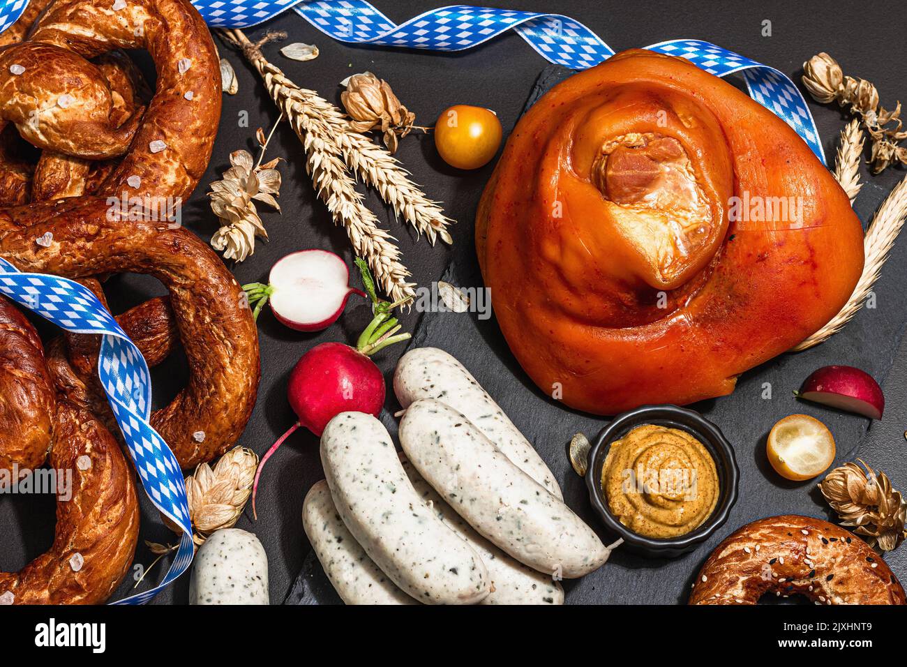 Traditional Oktoberfest set. Pretzels, weisswurst, smoked pork knuckle ...