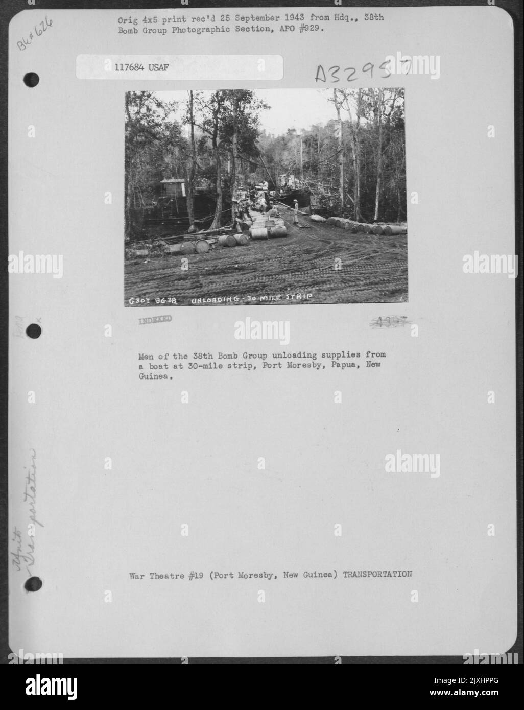 Men of the 38th Bomb Group unloading supplies from a boat at 30-mile ...
