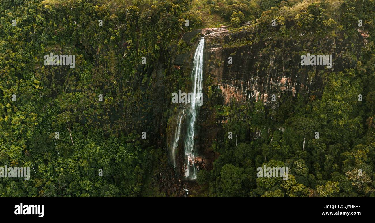 Natural Landscape with a huge waterfall from the mountains, green hills ...