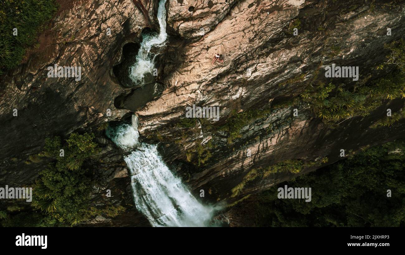 Natural Landscape with a huge waterfall from the mountains, green hills ...