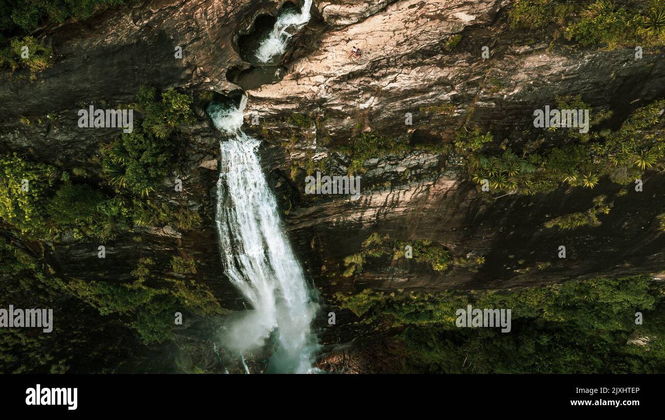 Natural Landscape with a huge waterfall from the mountains, green hills ...