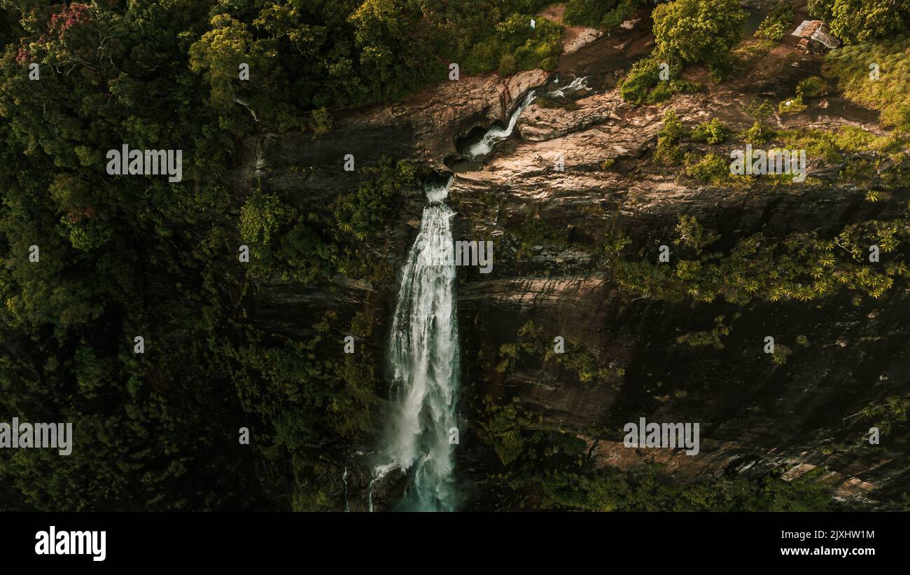 Natural Landscape with a huge waterfall from the mountains, green hills ...