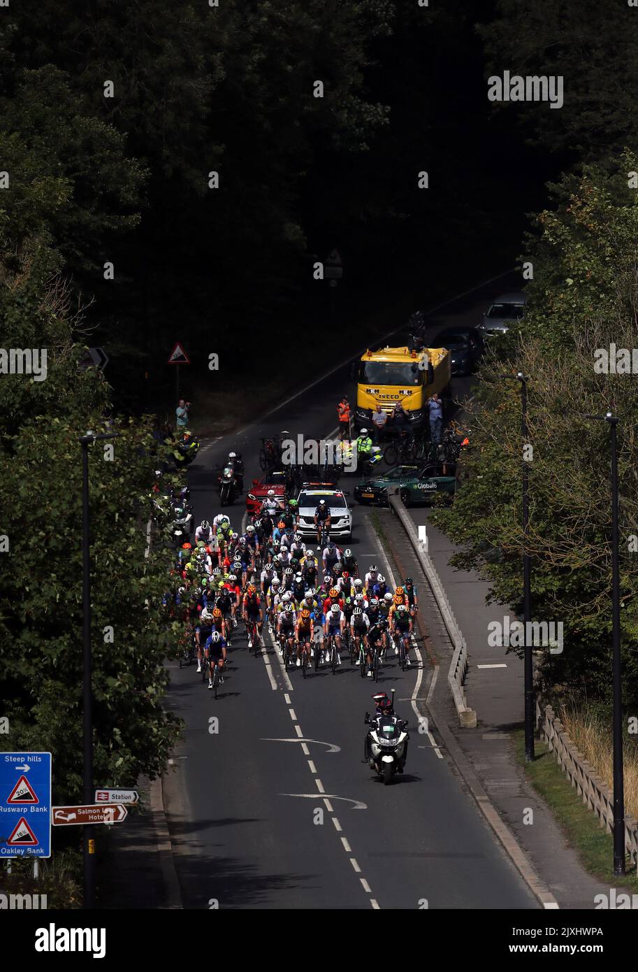 The peloton passes through the village of Sleights near Whitby during ...