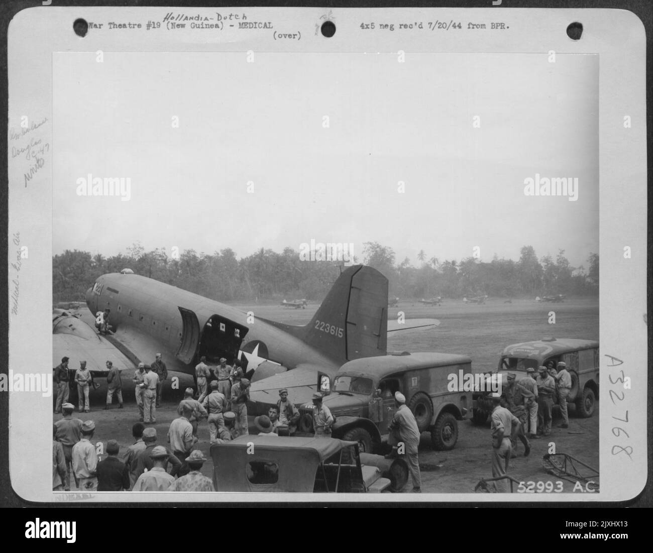 Ambulances from the 36th Evacuation Hospital at Hollandia bring litter ...
