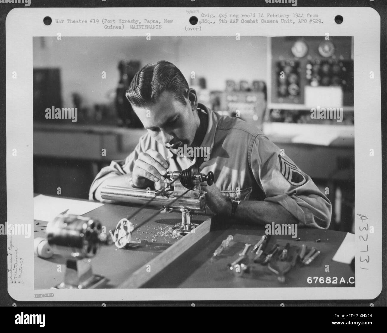 A "GI" uses a jeweler's lathe to make a pivot screw for an altimeter at ...