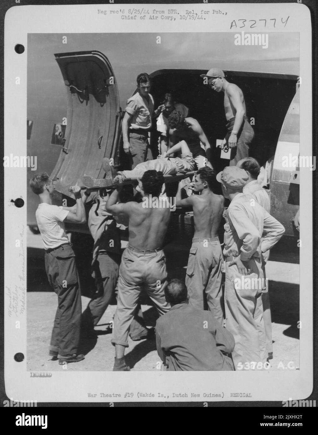 WAKDE ISLAND-Medical orderlies load the first patient aboard the ...