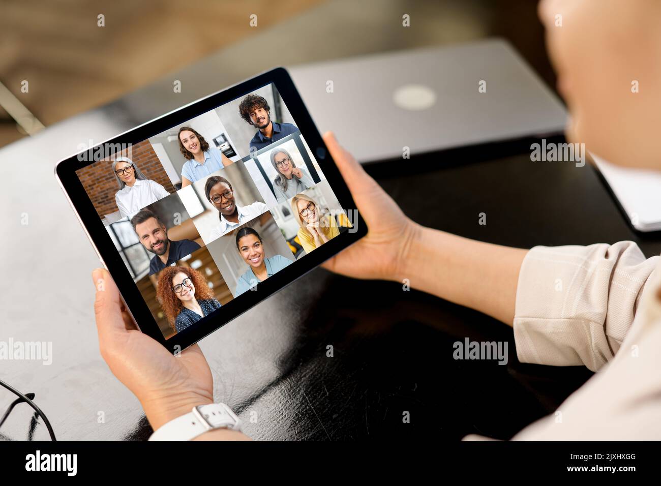Woman participates in video conference with multiracial team, virtual ...