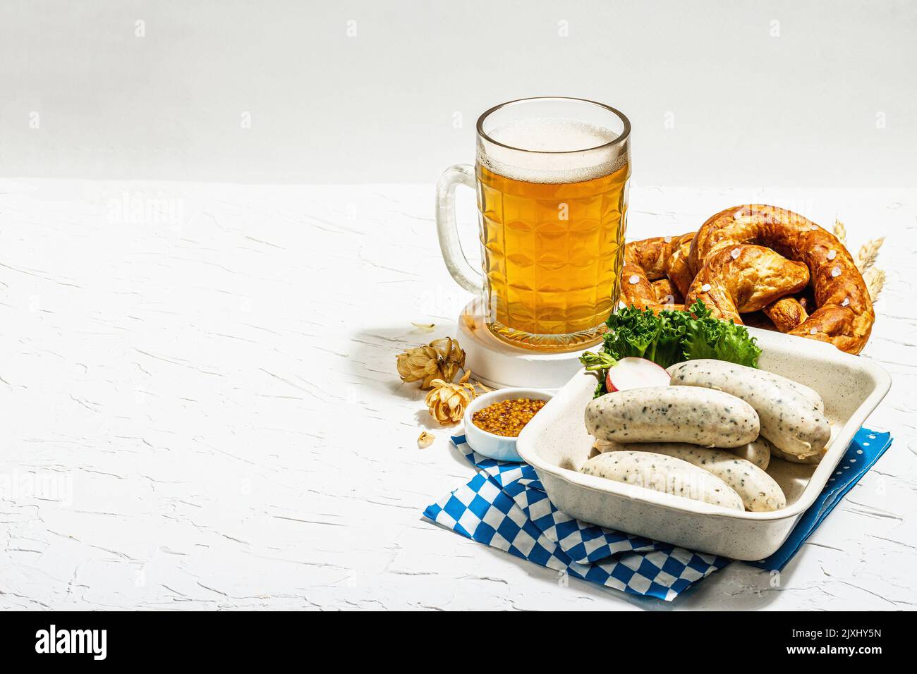 Traditional Oktoberfest set. Pretzels, beer, weisswurst with mustard ...