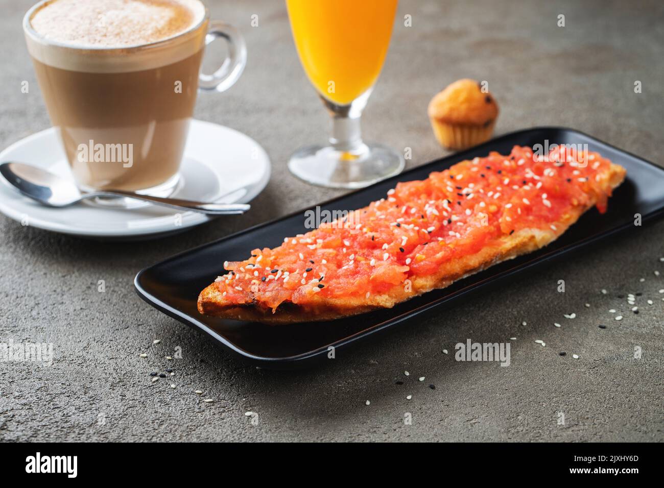 Traditional Spanish breakfast. Tostada with different toppings on a ...