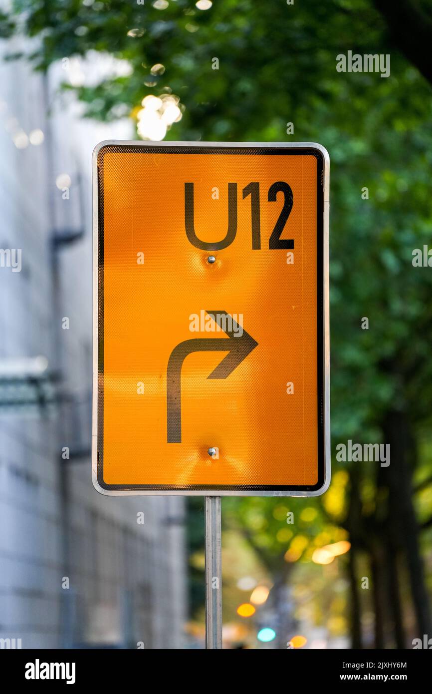 A vertical shot of orange rectangular U12 road sign with arrow Stock ...