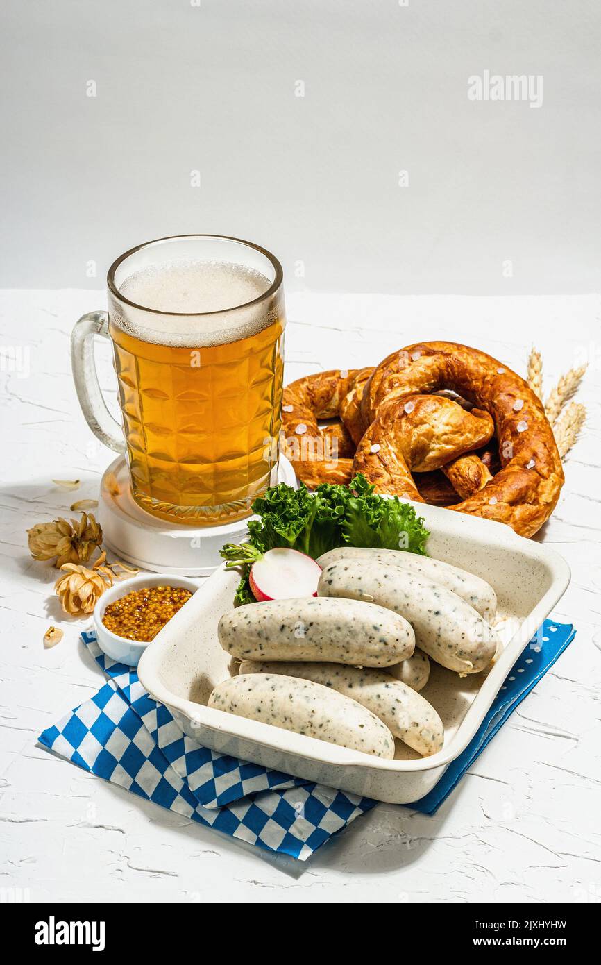 Traditional Oktoberfest set. Pretzels, beer, weisswurst with mustard ...