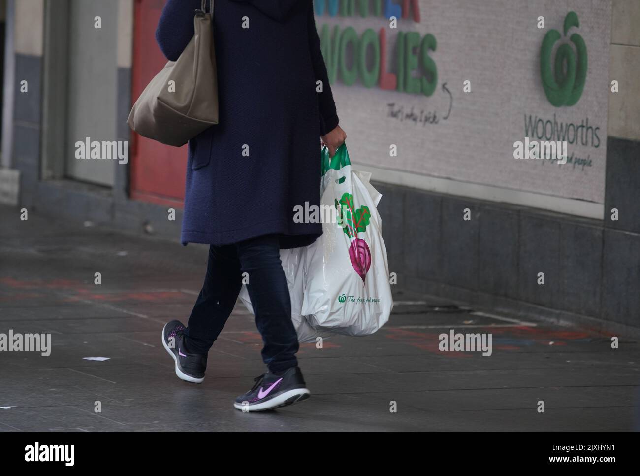 A customer is seen using a Woolworths re-useable plastic bag at ...
