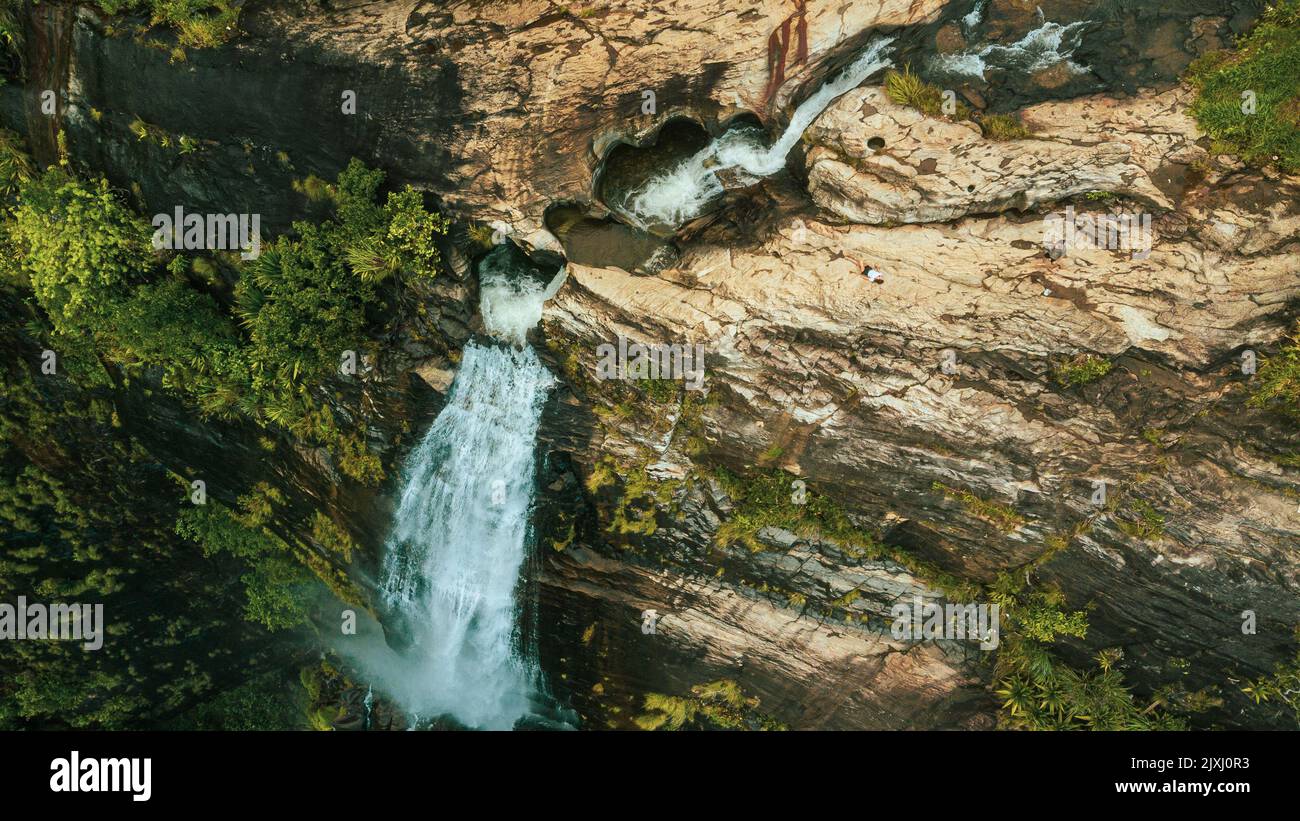 Natural Landscape with a huge waterfall from the mountains, green hills ...