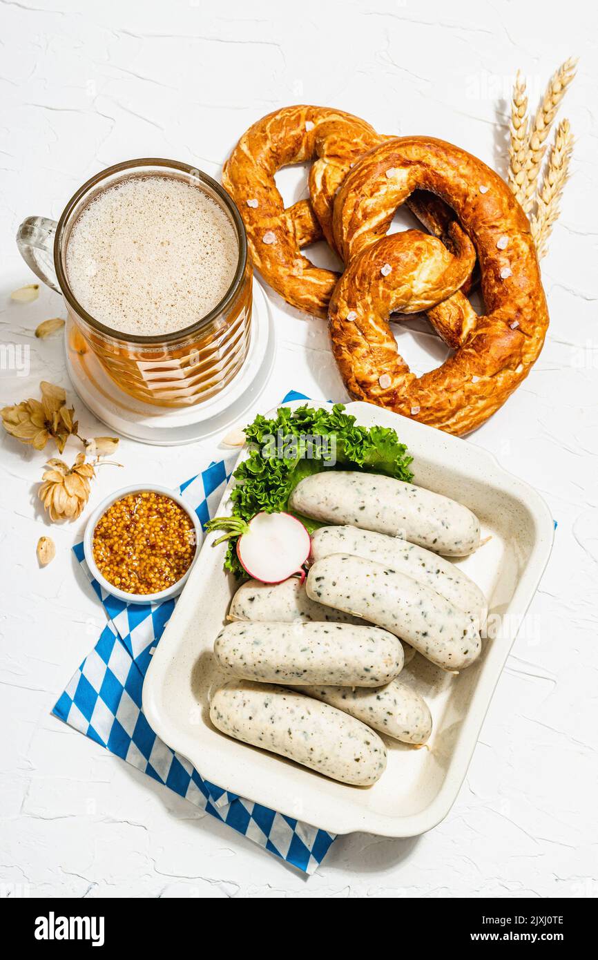Traditional Oktoberfest set. Pretzels, beer, weisswurst with mustard ...