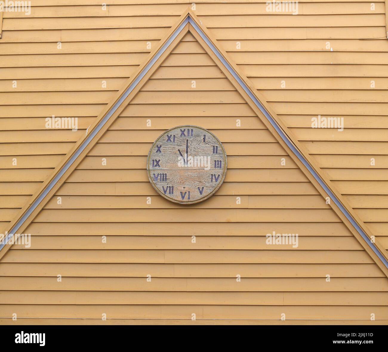 Wooden clock-face on exterior wooden wall with peak detail Stock Photo ...