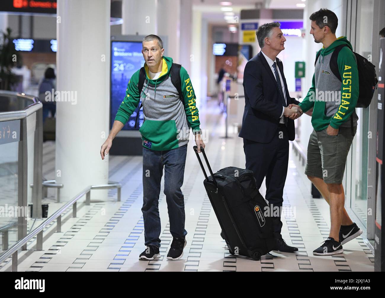 Anthony Moore, the CEO of Basketball Australia (centre) shakes hands ...
