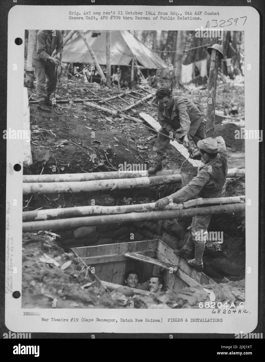 Men of the 390th Bomb Squadron, 42nd Bomb Group digging a well to ...