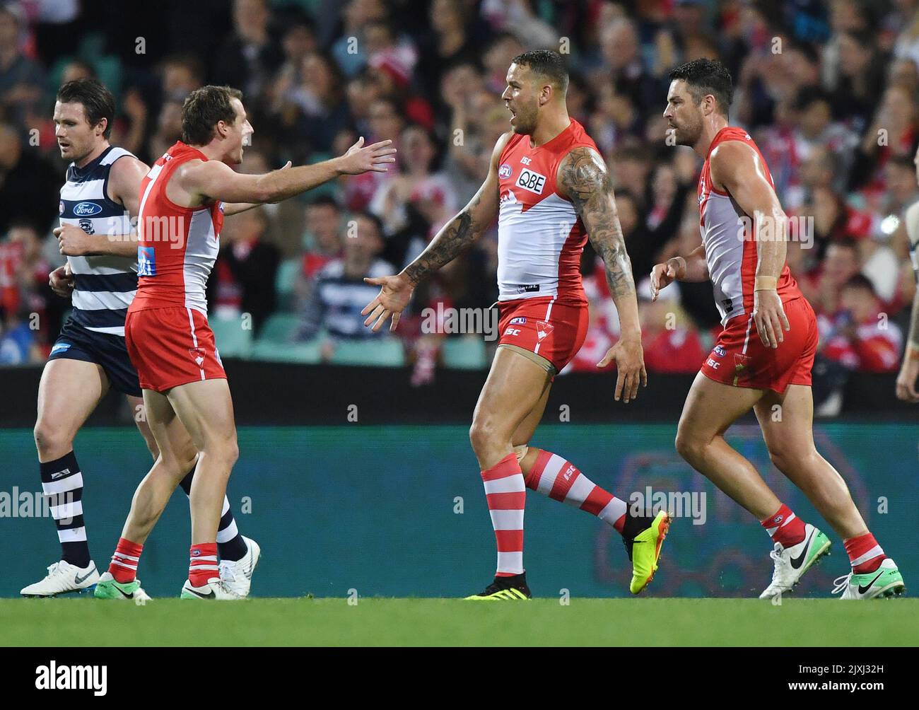 Lance Franklin of the Swans (centre) celebrates kicking a goal during ...