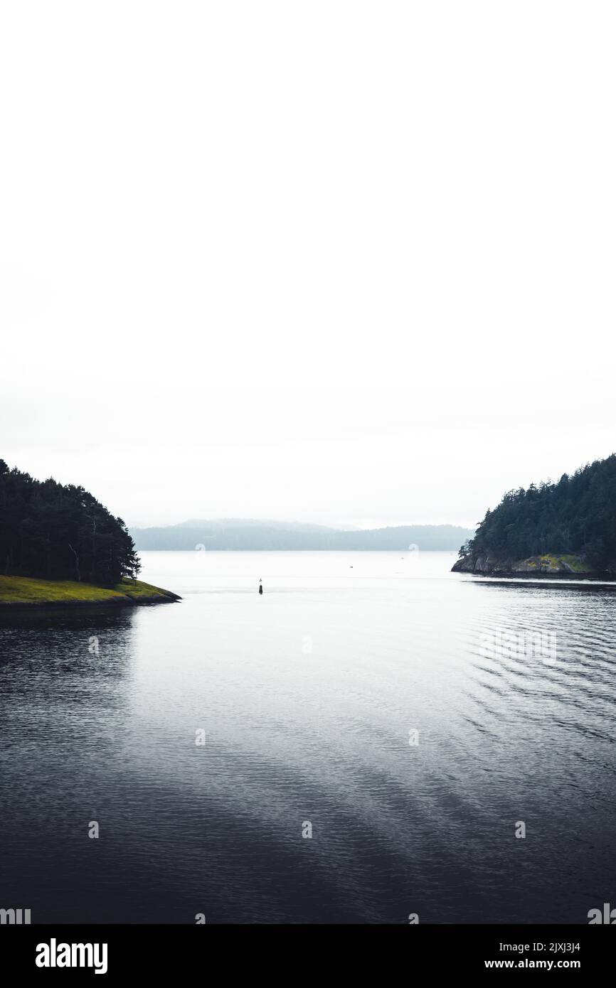 An aerial view of ocean inlet between two coastal mountain forests ...