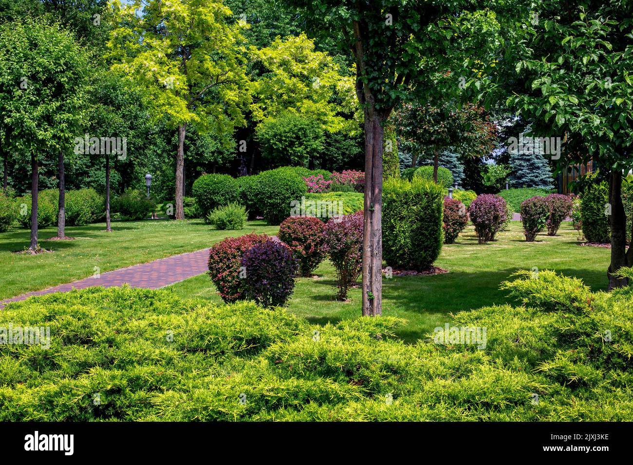 a scenic park with walking paths for walking among green plantings of ...