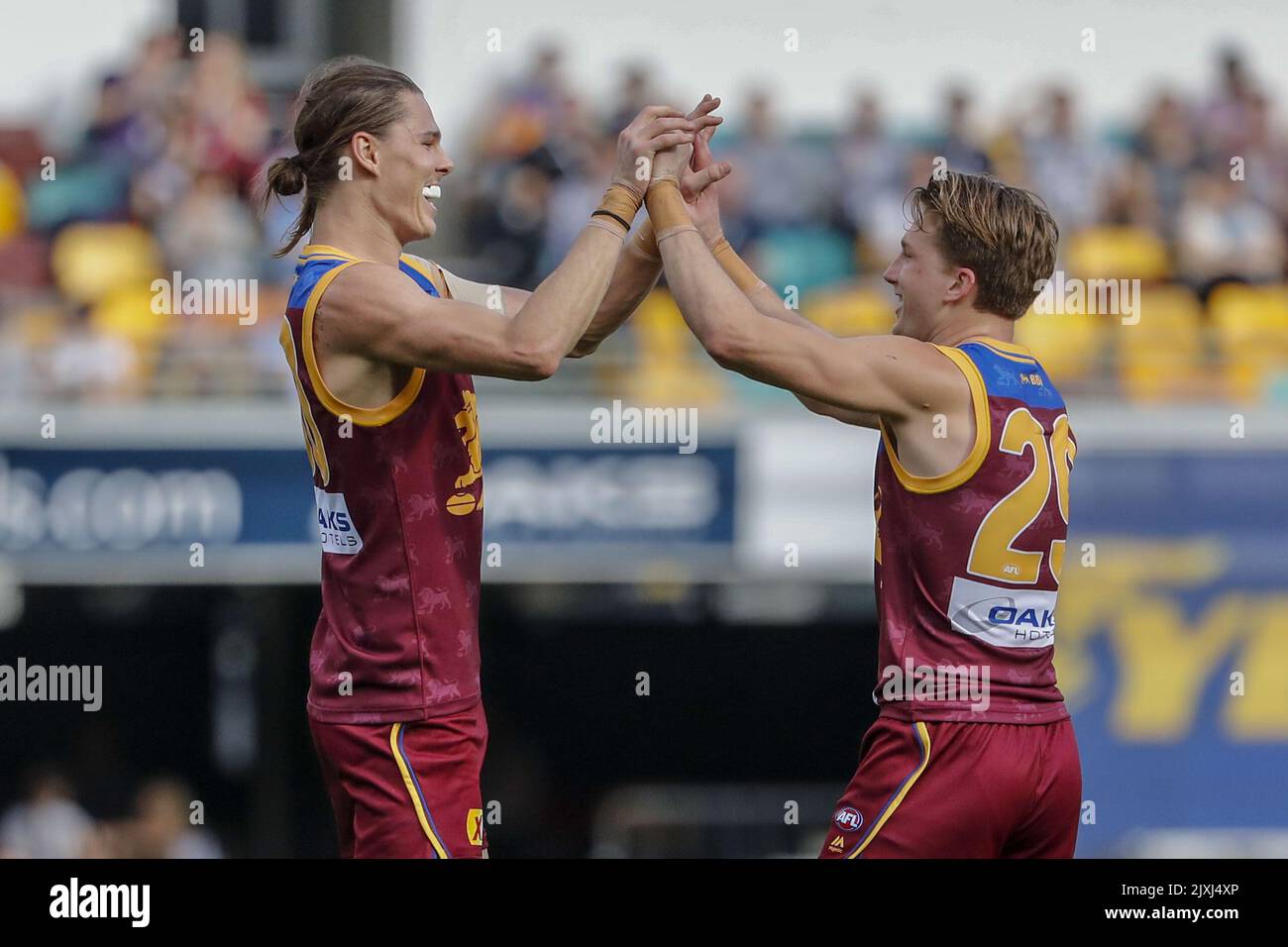 Eric Hipwood of the Lions (left) celebrates a goal during the Round 16 ...