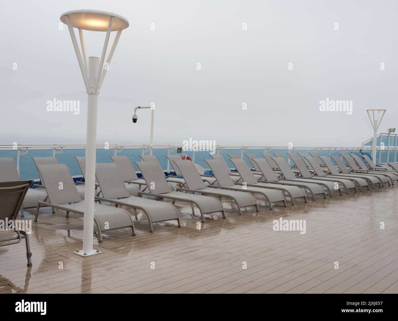 Surreal and paradoxical scene - wet afternoon on the sun deck of a ...