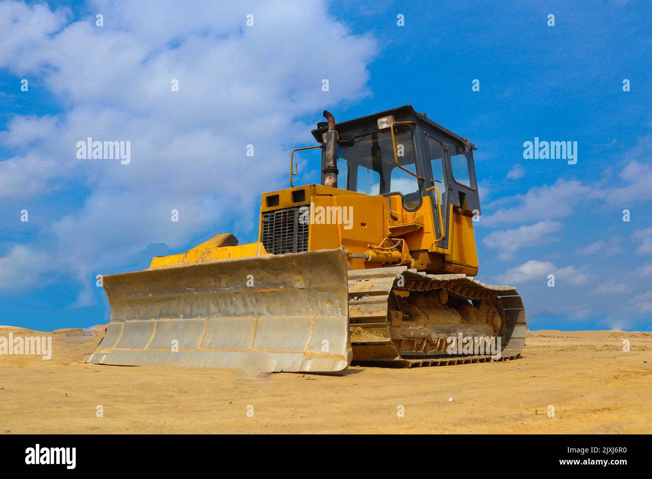 bulldozer with yellow color, on construction site and sky background ...