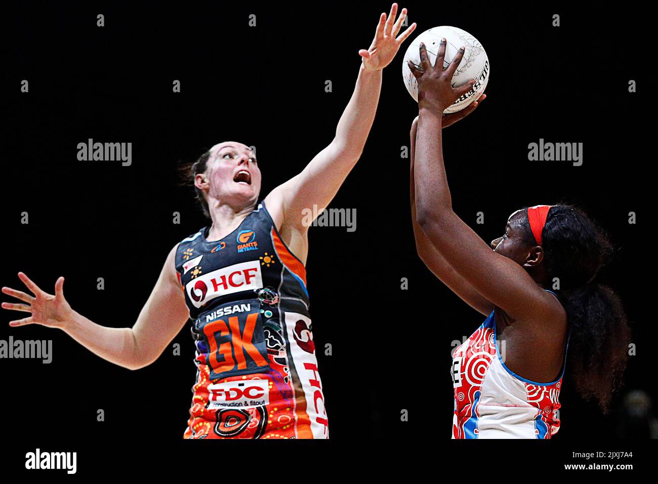 Sam Wallace of the Swifts (right) shoots as Sam Poolman of the Giants ...