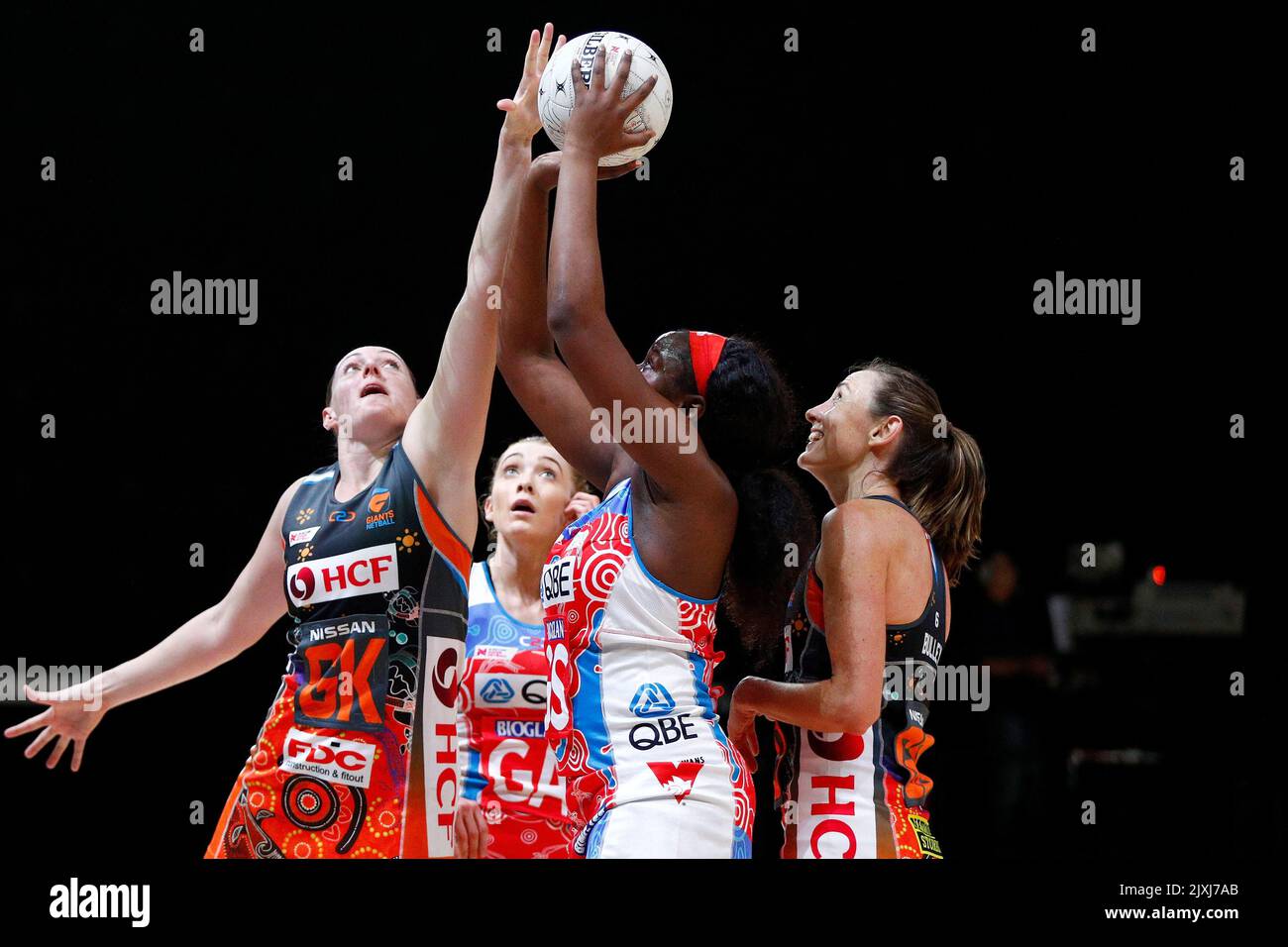 Sam Wallace of the Swifts (second right) shoots as Sam Poolman of the ...