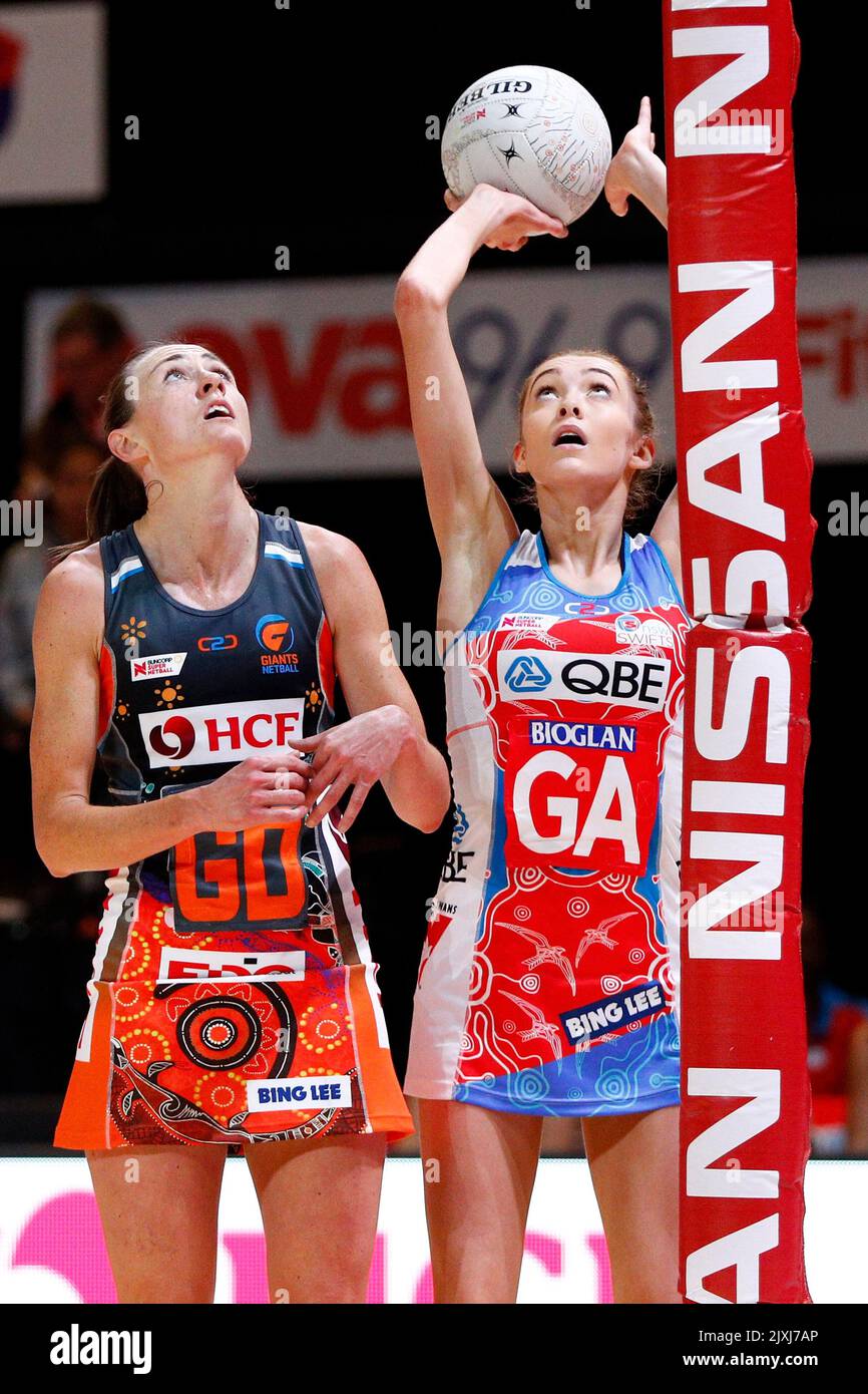 Helen Housby of the Swifts (right) shoots as Bec Bulley of the Giants ...