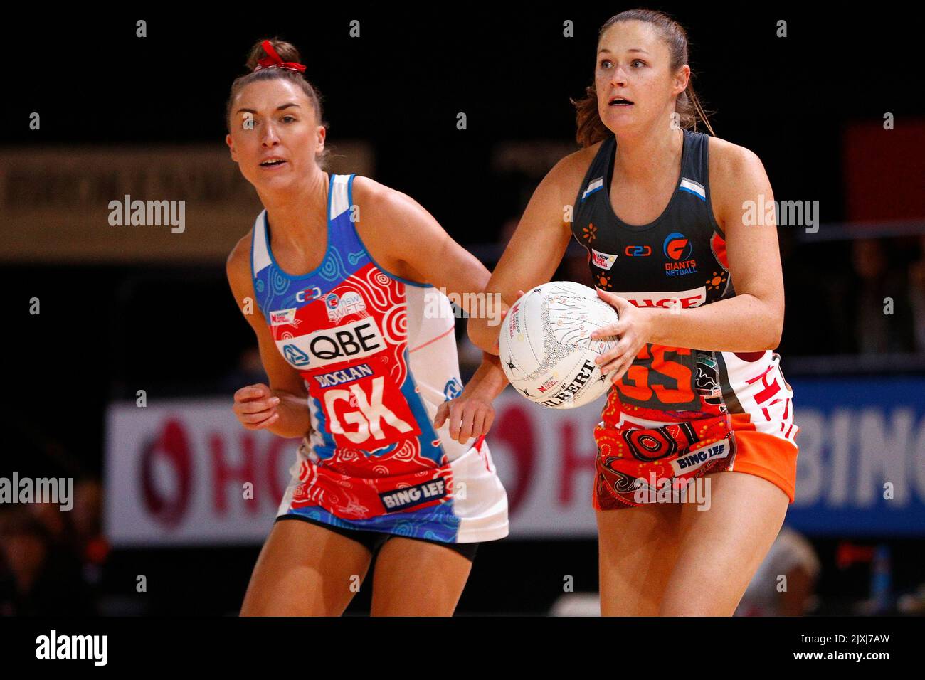 Susan Pettitt of the Giants (right) looks to pass as Sarah Klau of the ...