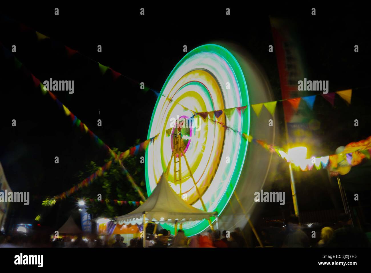 Ferris wheel at night festival in slow motion photo. High Roller Stock ...