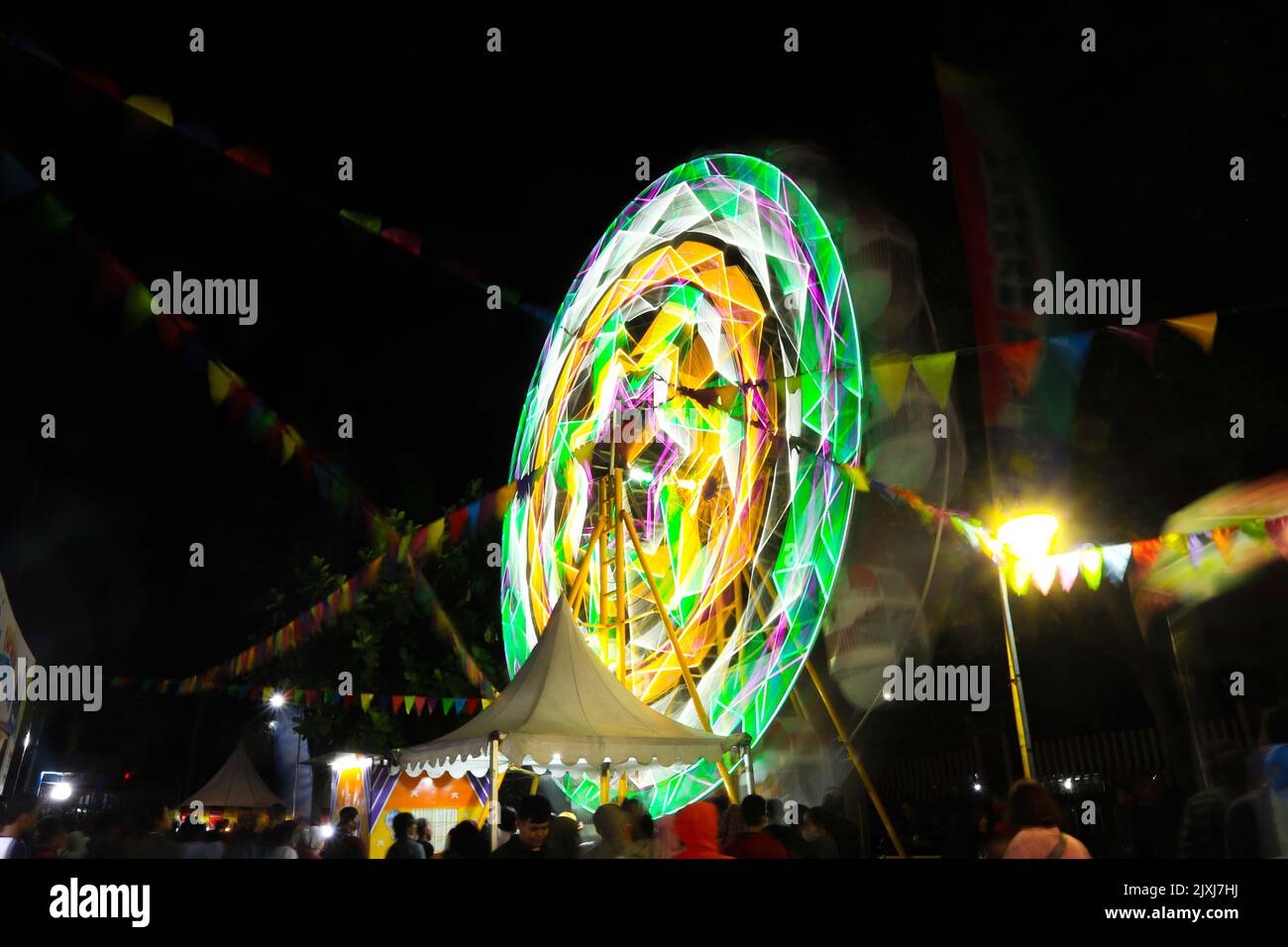 Ferris wheel at night festival in slow motion photo. High Roller Stock ...