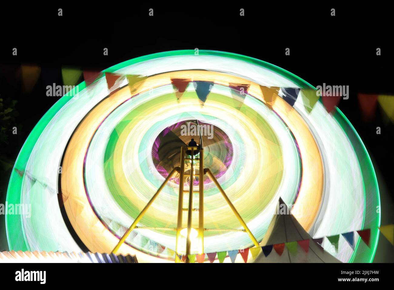 Ferris wheel at night festival in slow motion photo. High Roller Stock ...