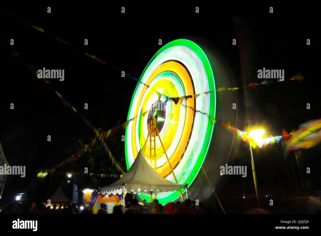 Ferris wheel at night festival in slow motion photo. High Roller Stock ...