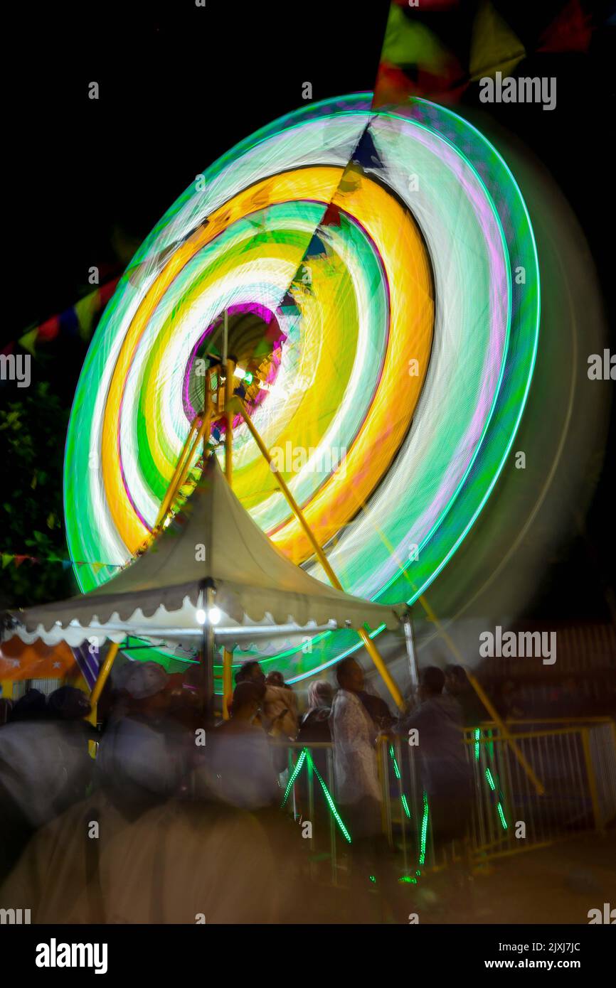 Ferris wheel at night festival in slow motion photo. High Roller Stock ...