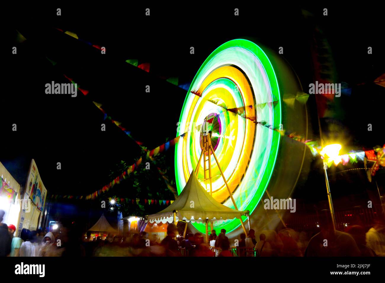 Ferris wheel at night festival in slow motion photo. High Roller Stock ...