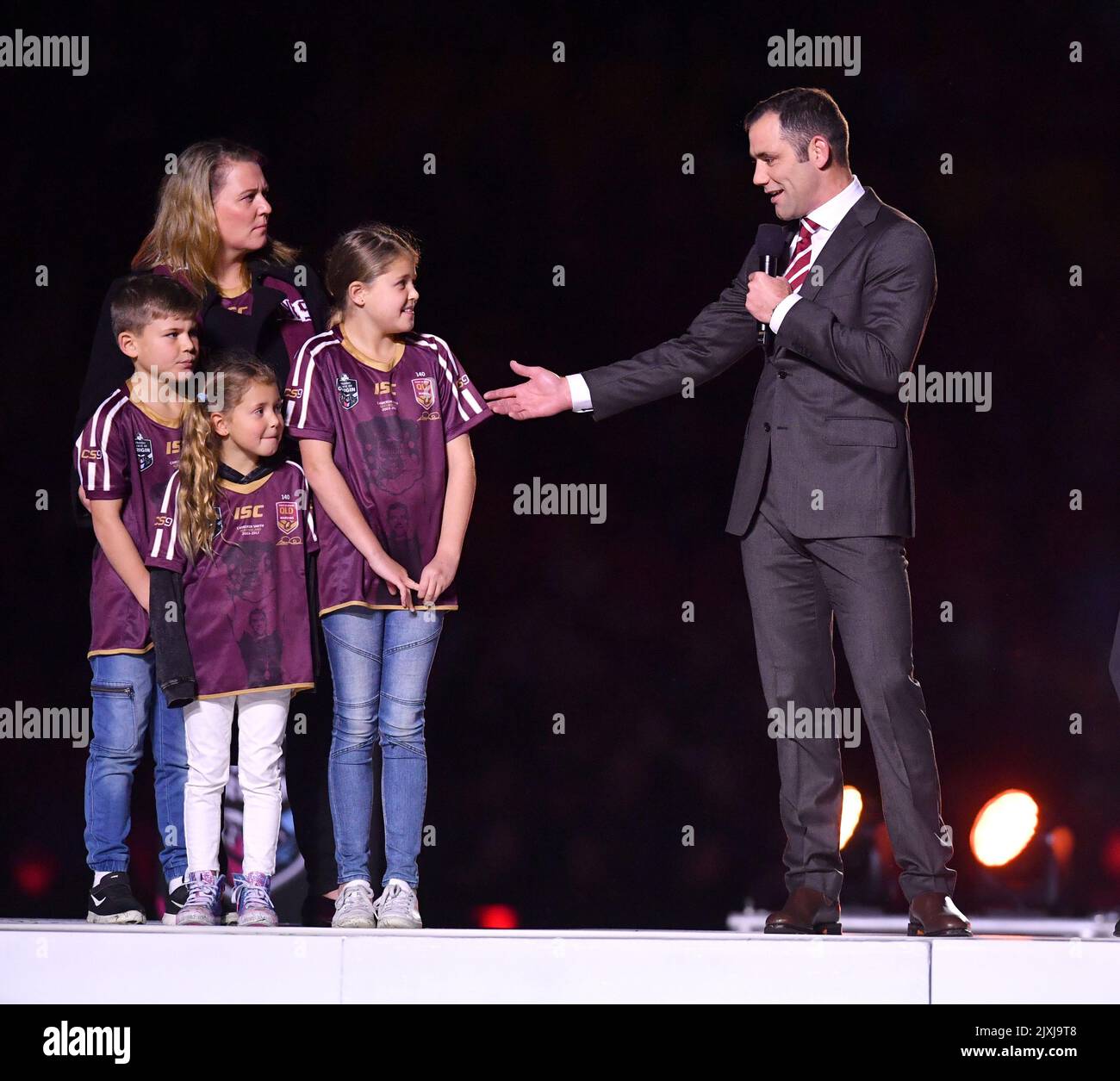 Former Queensland Maroons captain Cameron Smith (right) stands with his ...