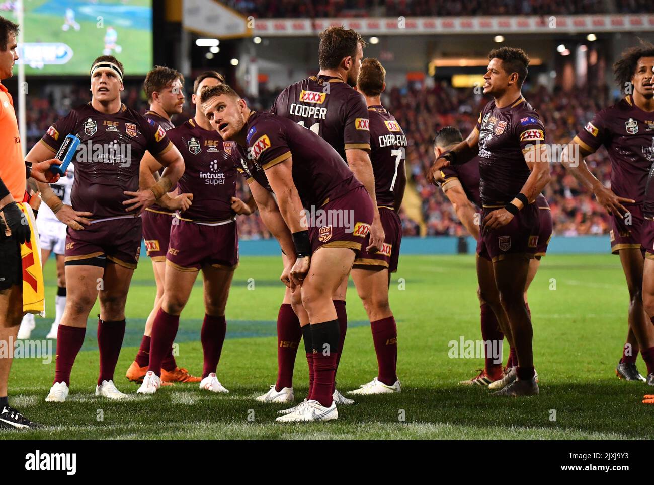 Maroons players are seen after a try by James Tedesco of the Blues ...