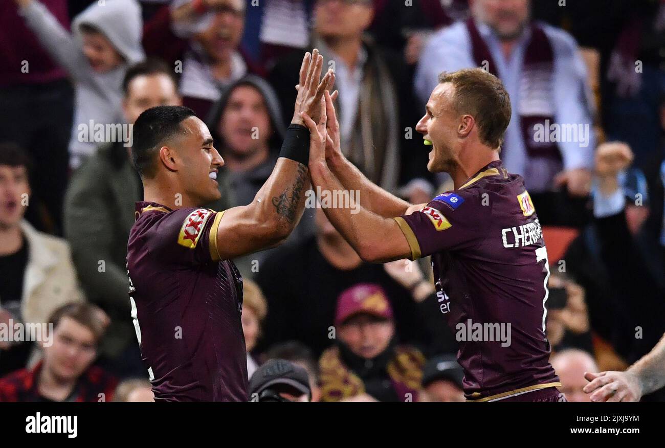 Valentine Holmes (left) of the Maroons celebrates scoring a try with ...