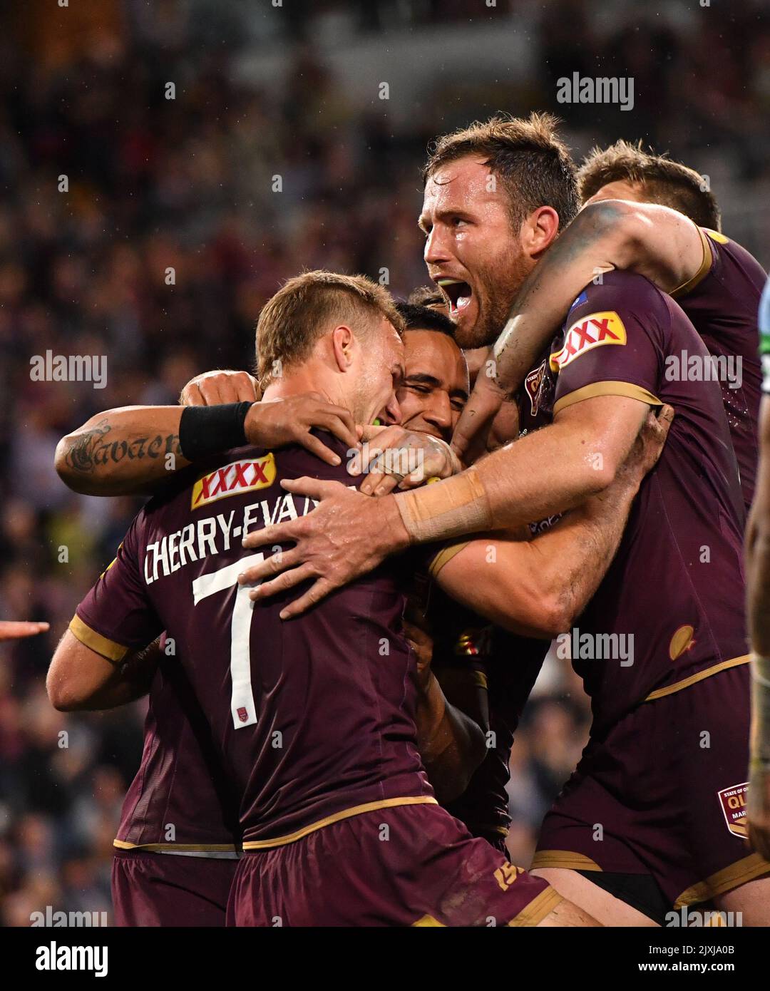 Daly Cherry-Evans (left) of the Maroons celebrates scoring a try with ...