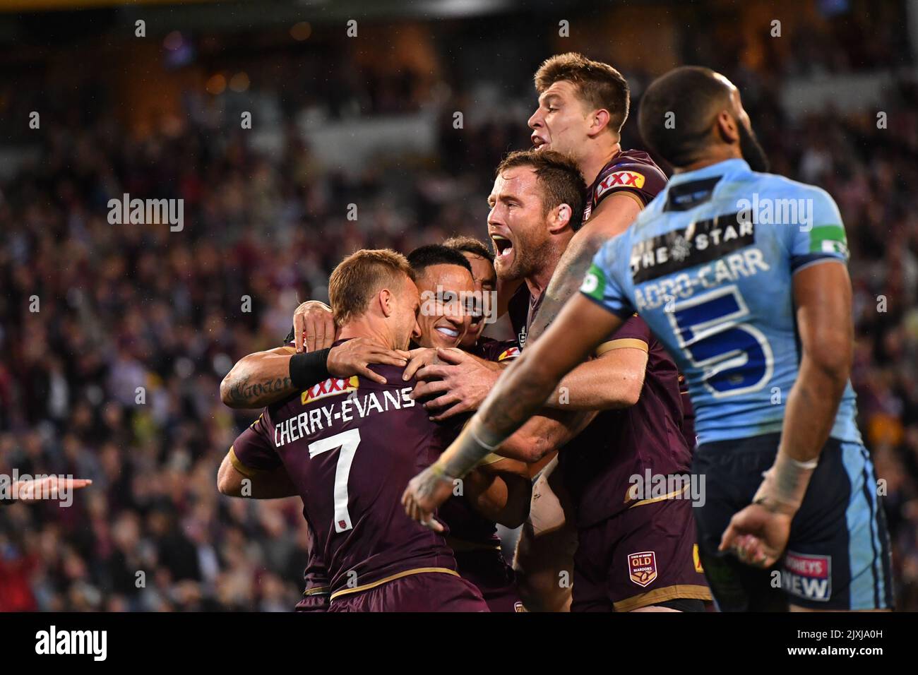 Daly Cherry-Evans (left) of the Maroons celebrates scoring a try with ...