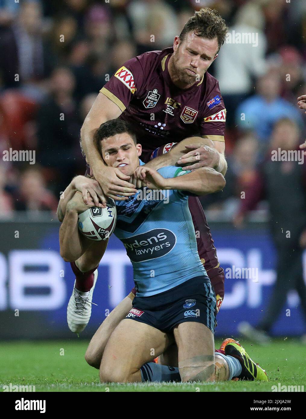Gavin Cooper of the Maroons (top) tackles Nathan Cleary of the Blues ...