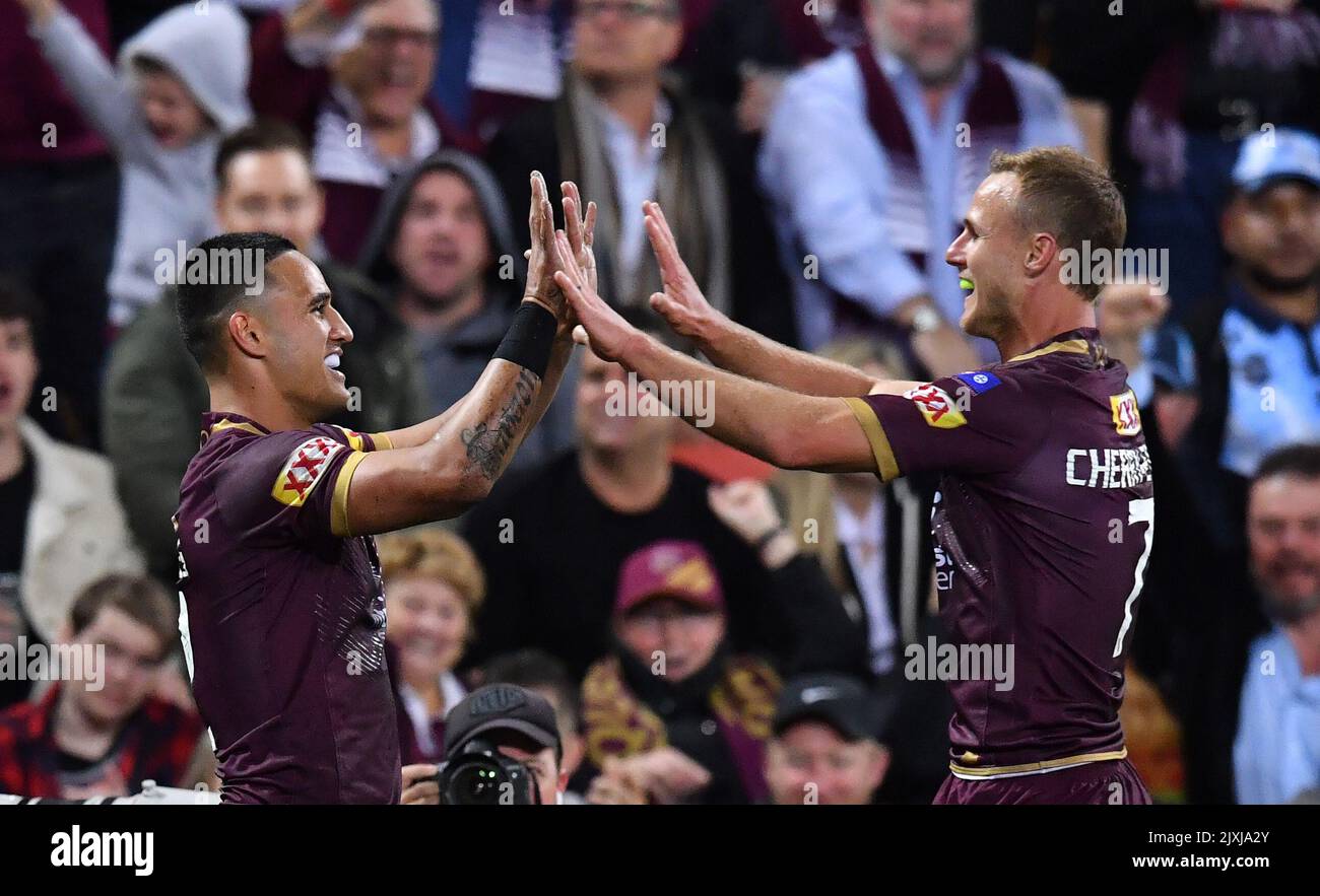 Valentine Holmes (left) of the Maroons celebrates scoring a try with ...
